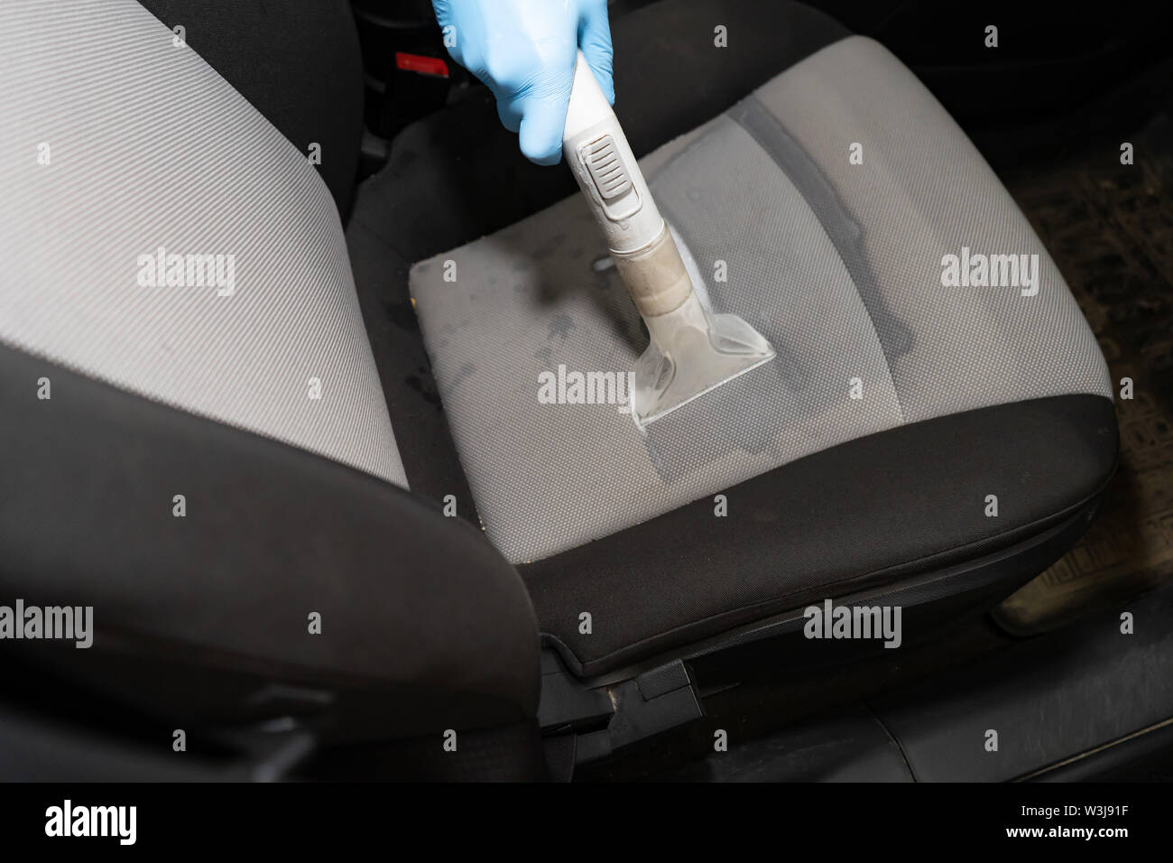 Dry cleaning salon cars. Worker uses washing vacuum in the car Stock ...