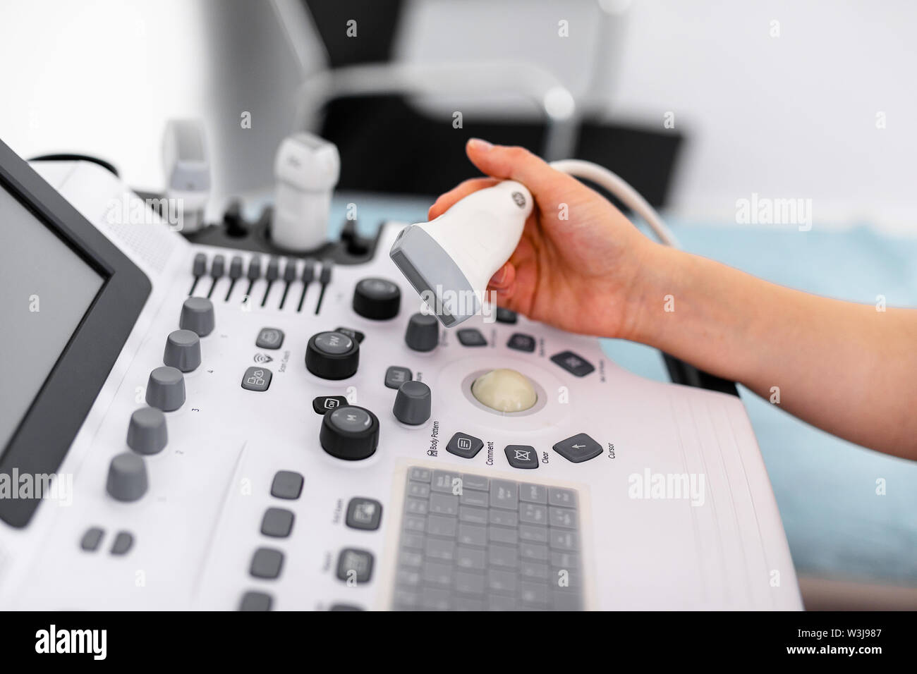 Ultrasound sensor of modern ultrasonic scanner in young woman doctor's ...