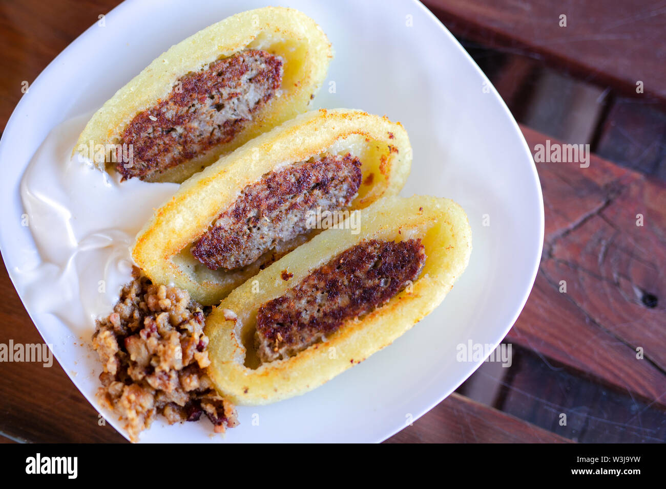 Fried cepelinai, dumplings from grated and riced potatoes and stuffed ...
