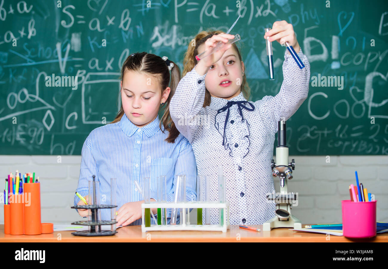 Little kids learning chemistry. Chemistry equipment. students do ...
