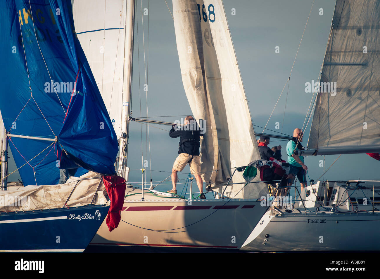 Sailing together. Group of sailboats make ready for sail in light wind ...