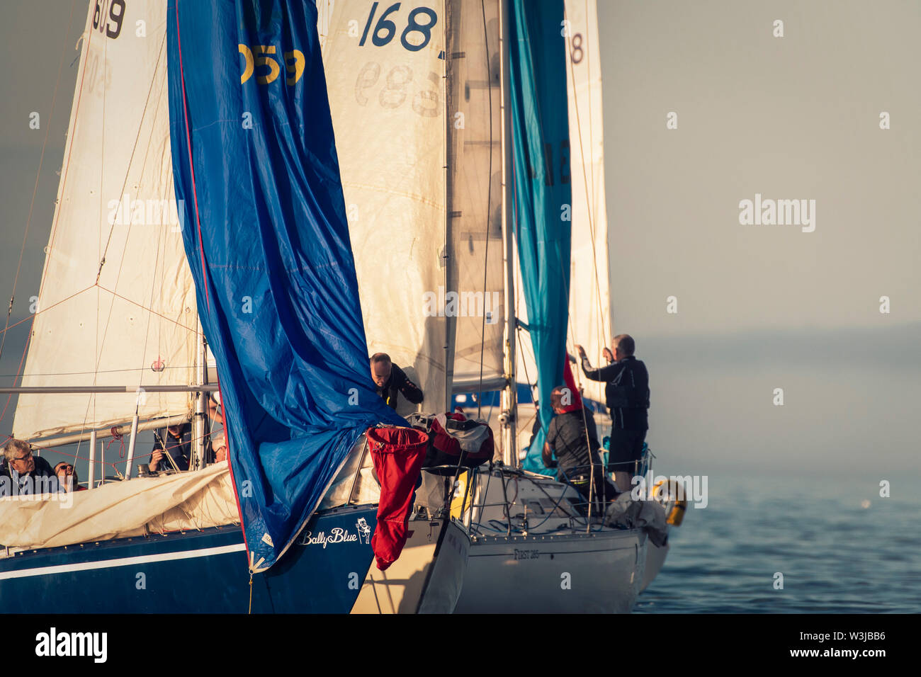 Sailing together. Group of sailboats make ready for sail in light wind ...