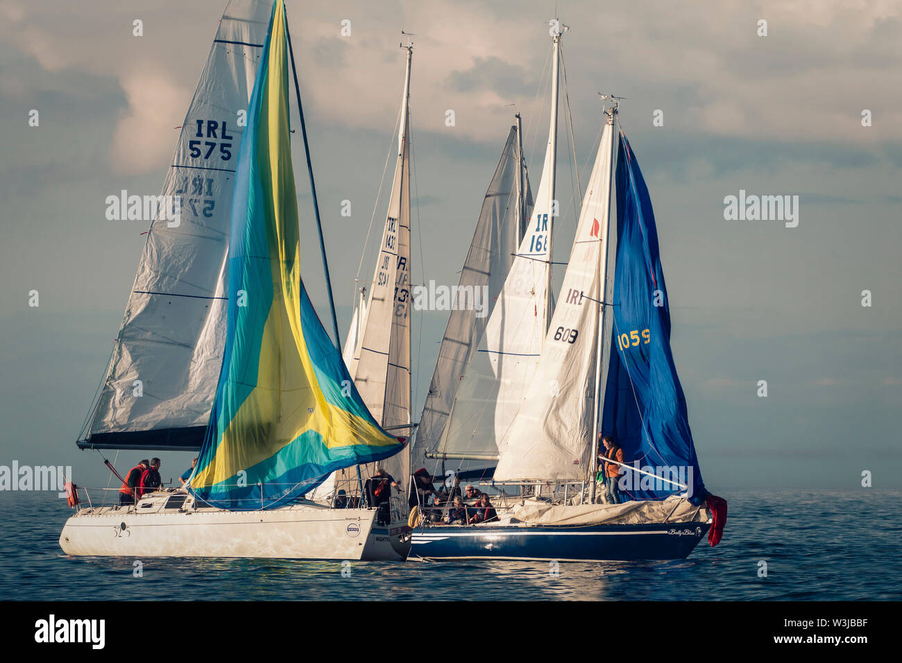 Sailing together. Group of sailboats sailing in a company. Just before ...