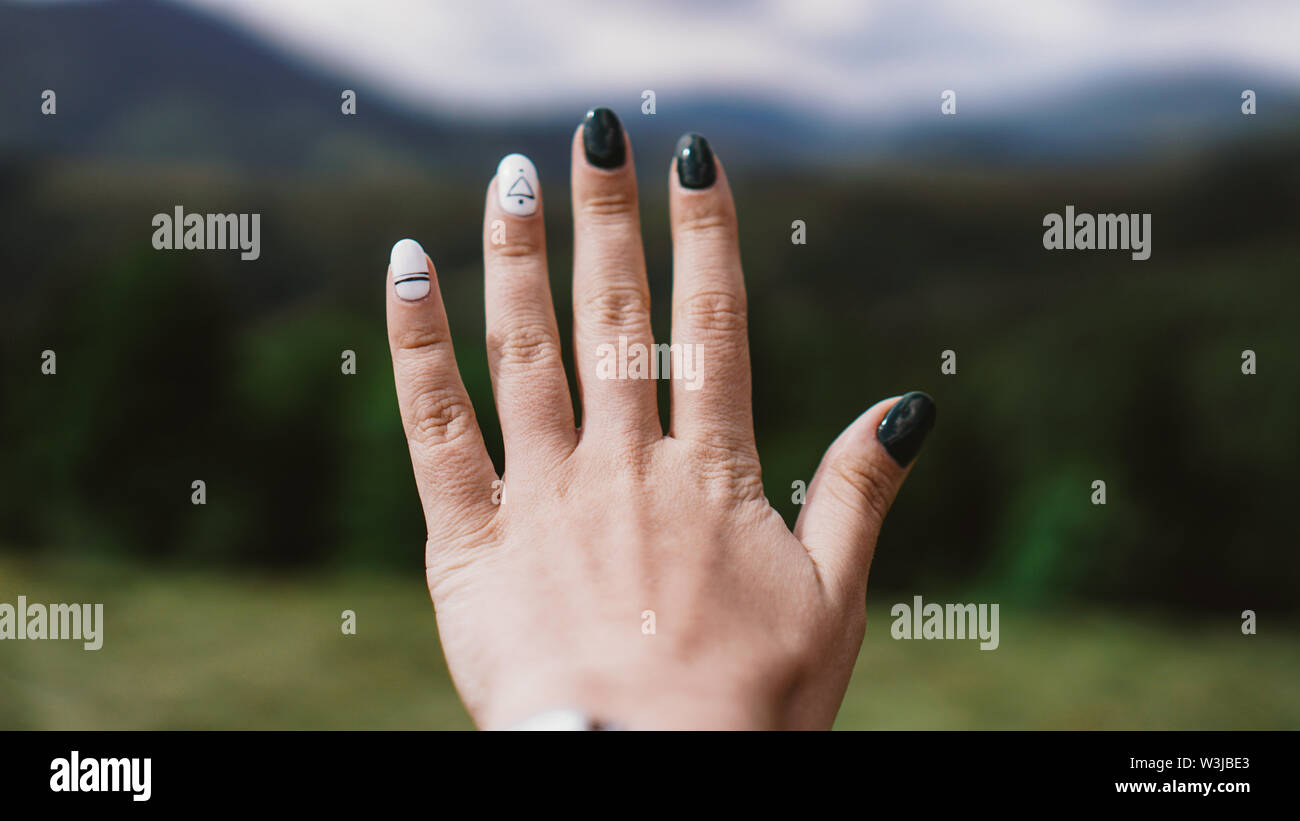 Hand against mountain. Female hand forward. Mountain valley. Natural ...