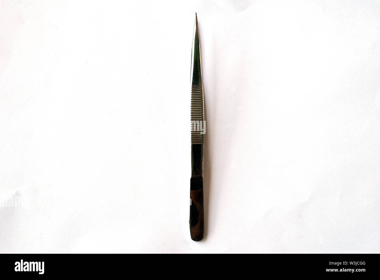 Pointed tip pliers used for capturing small parts on a white background ...