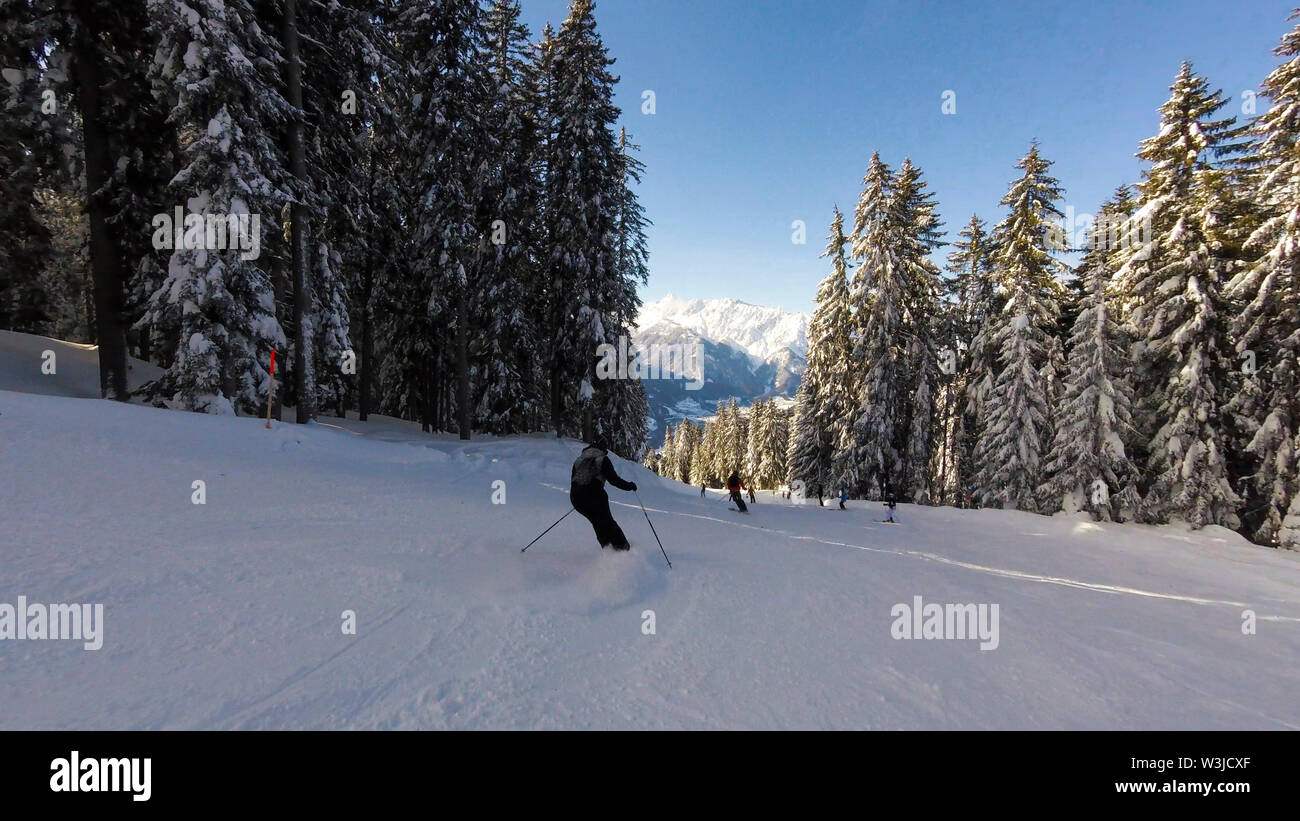Skiers at a blue piste Stock Photo - Alamy
