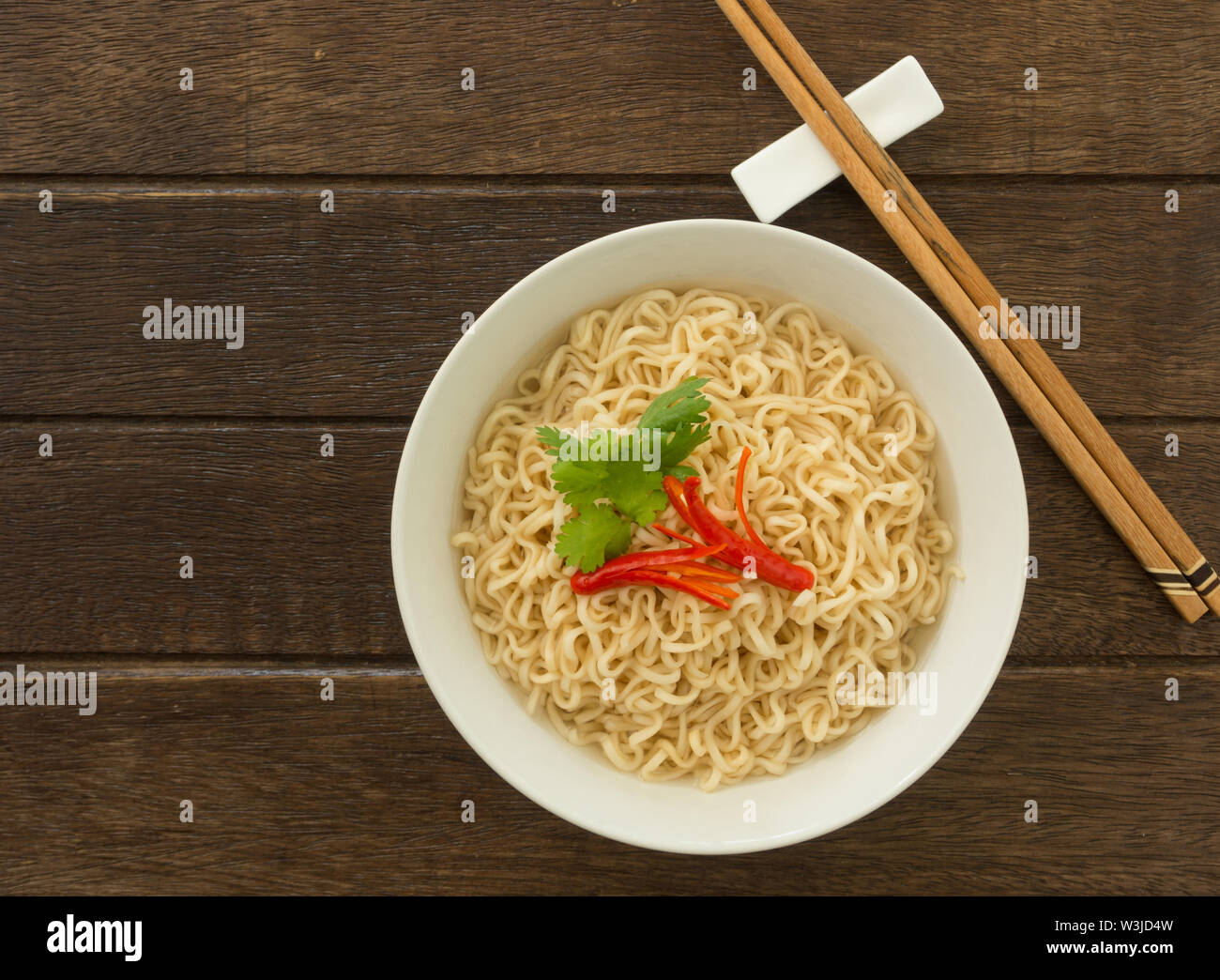Instant noodles in bowls on wood table. top view Stock Photo - Alamy
