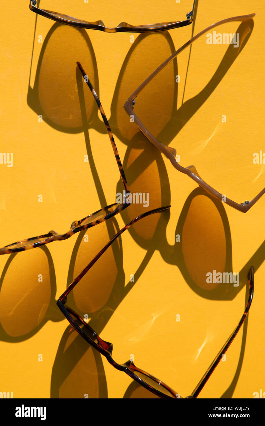 Sunglasses with long shadow on a brignt summer yellow background Stock ...