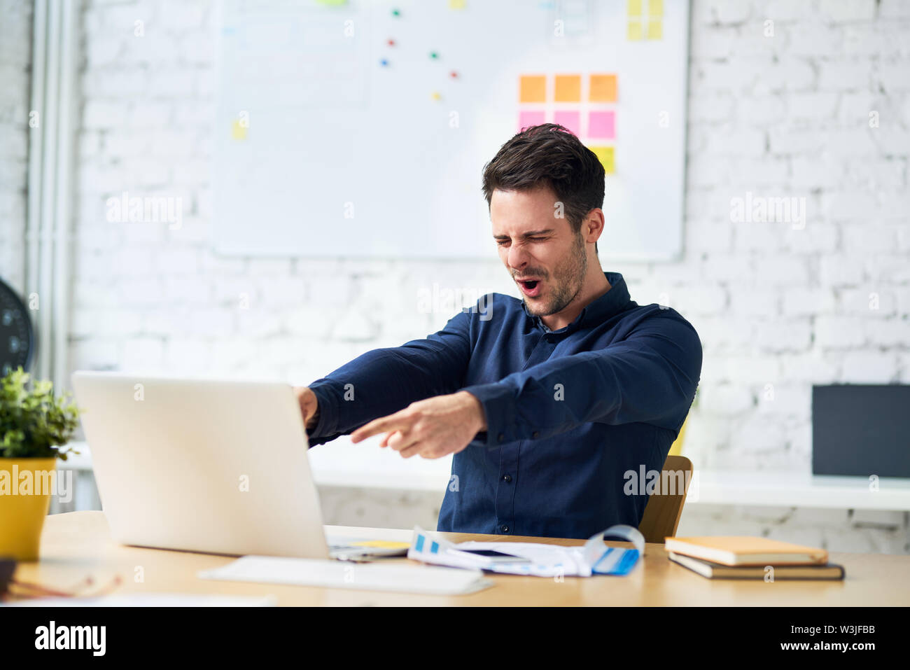 Businessman celebrating working on laptop hi-res stock photography and ...