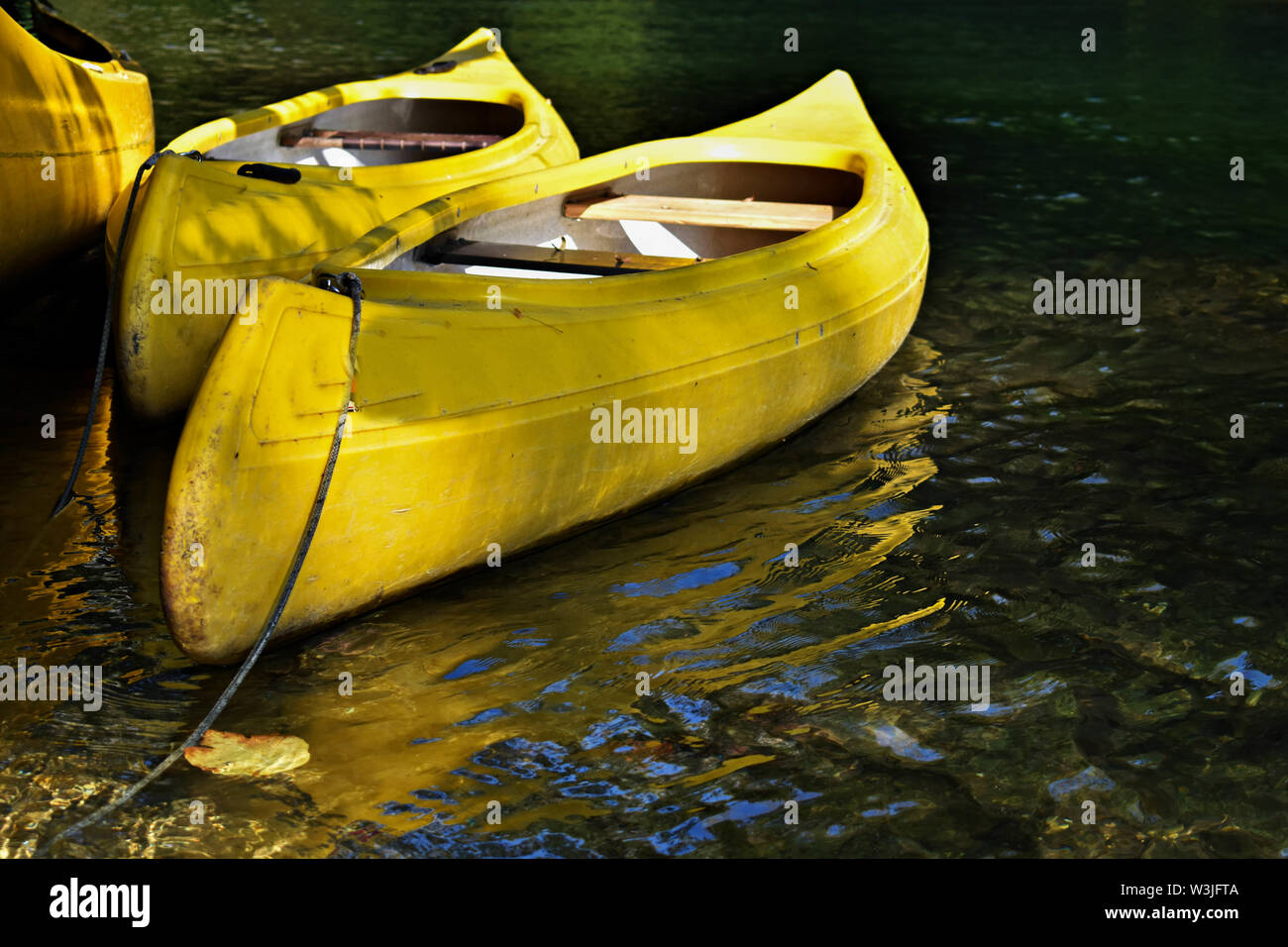 Kayaking on peaceful calm water/ Yellow kayak at beautiful green river ...