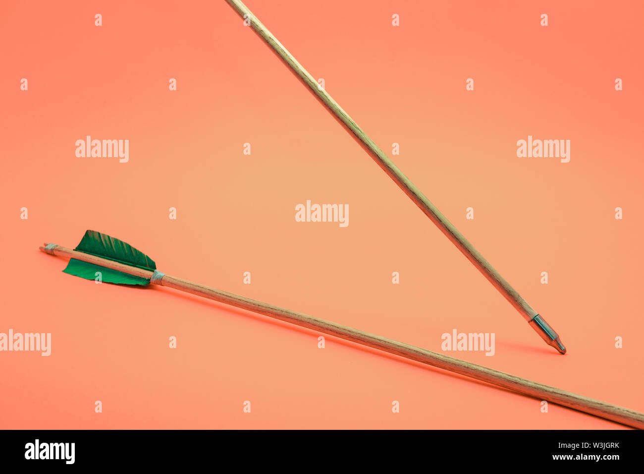 Old two green wooden arrow on a beautiful peach background Stock Photo ...