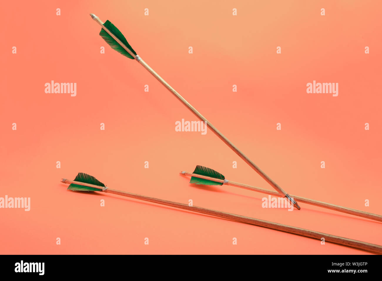 Old three green wooden arrow on a beautiful peach background Stock ...
