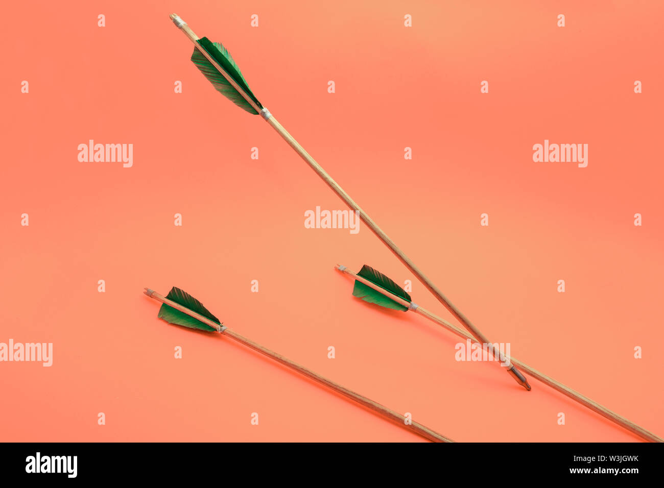 Old three green wooden arrow on a beautiful peach background Stock ...