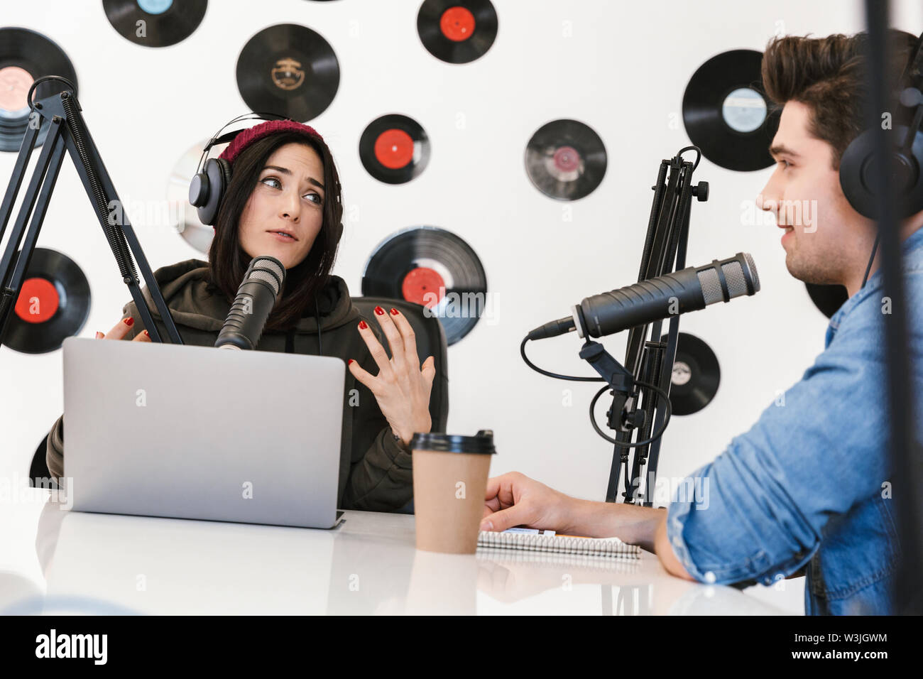 Image of a handsome young man radio host with colleague woman at the ...