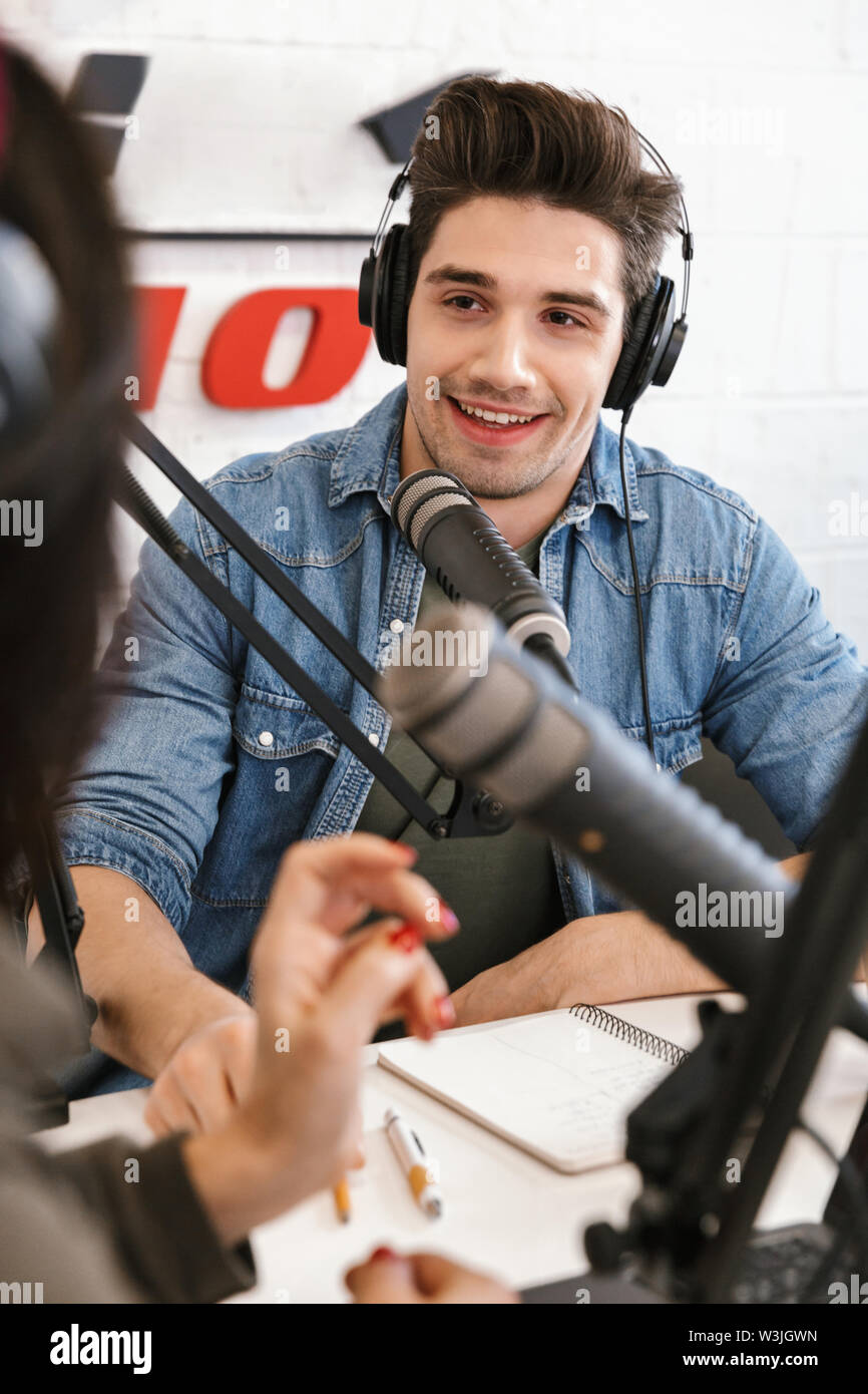 Image of a handsome young man radio host with colleague woman at the ...