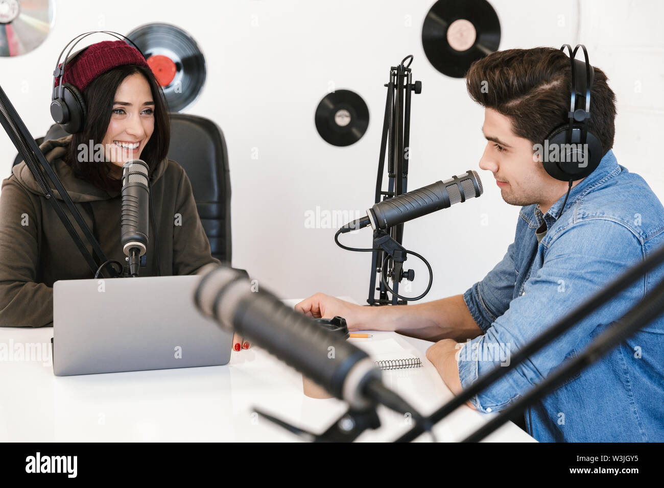 Image of a handsome young man radio host with colleague woman at the ...