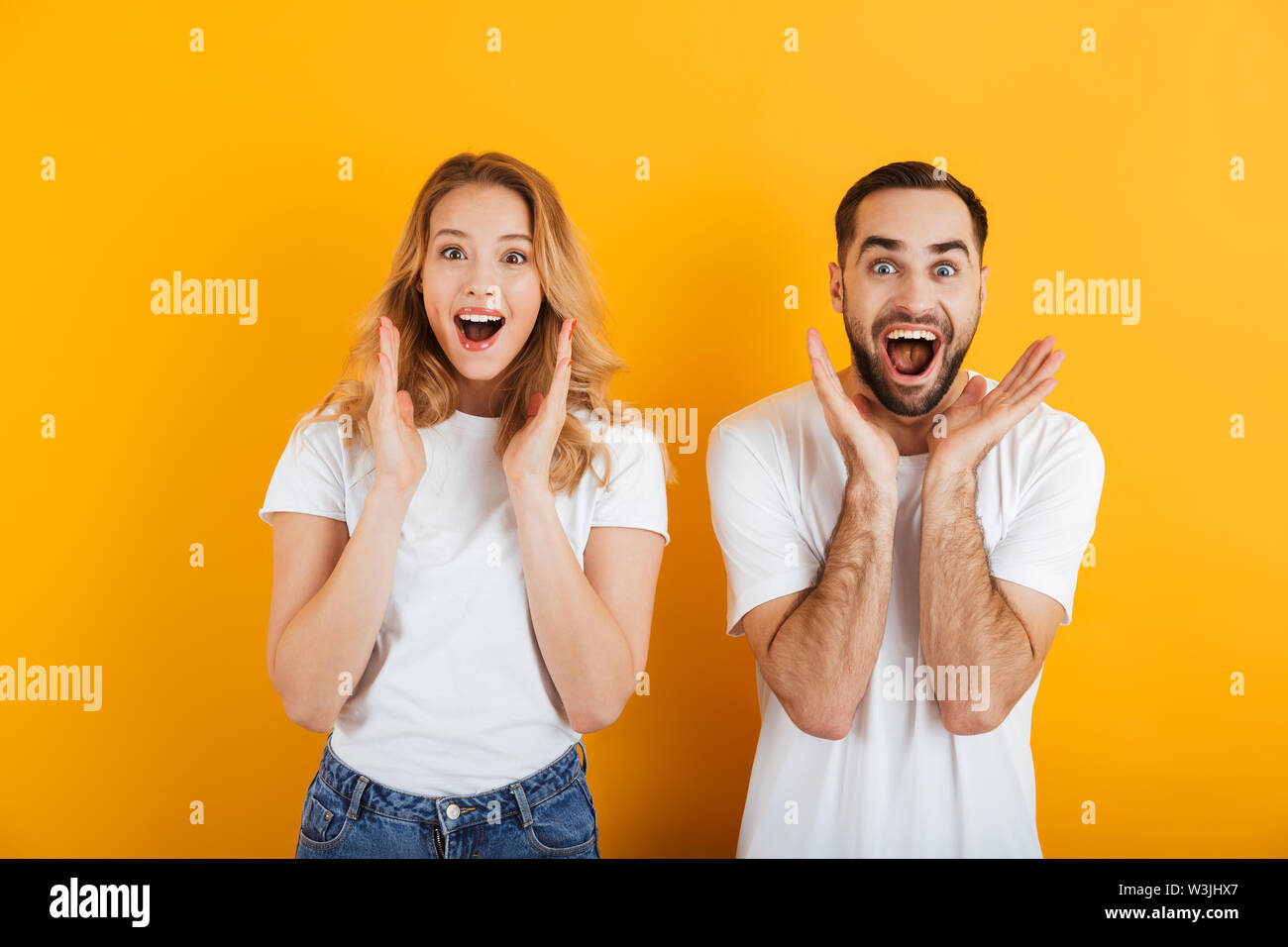 Image of excited people man and woman in basic clothing expressing ...