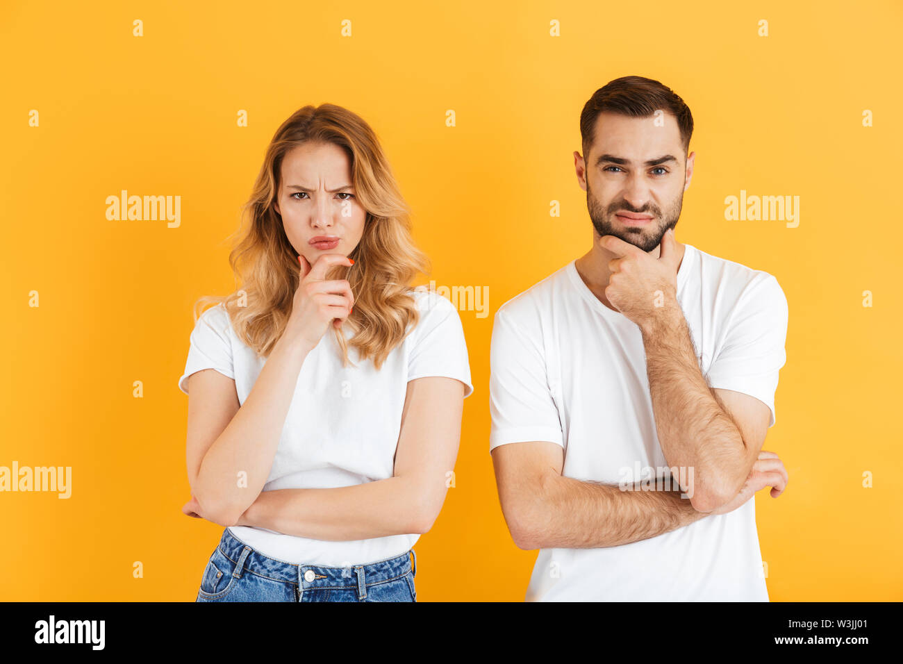 Image of irritated couple man and woman frowning and touching their ...