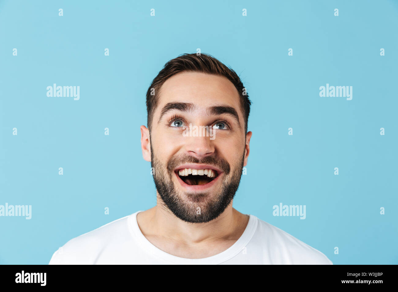 Image of dreaming smiling young happy bearded man posing isolated over ...