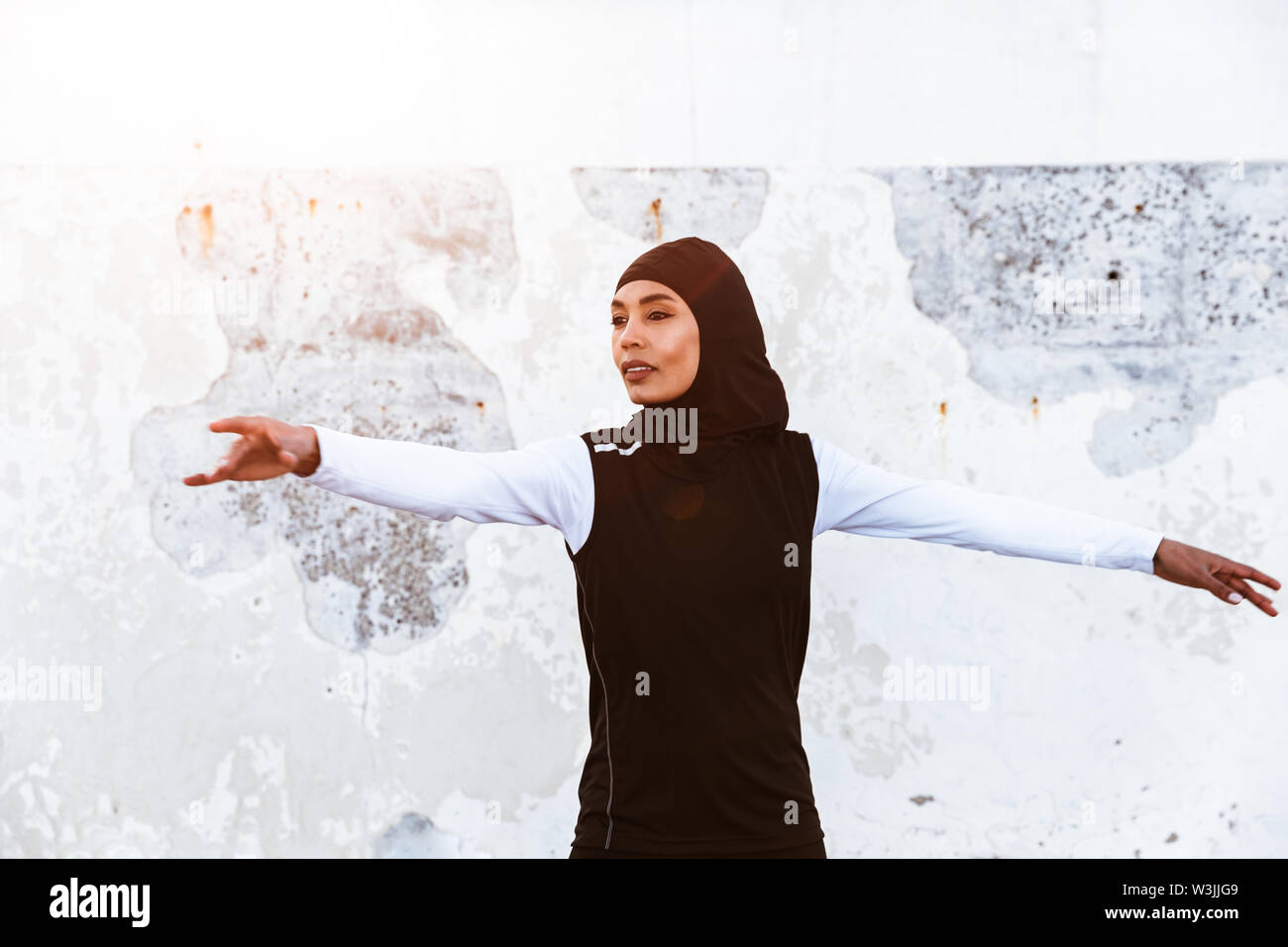 Image of a young concentrated muslim sports fitness woman dressed in ...
