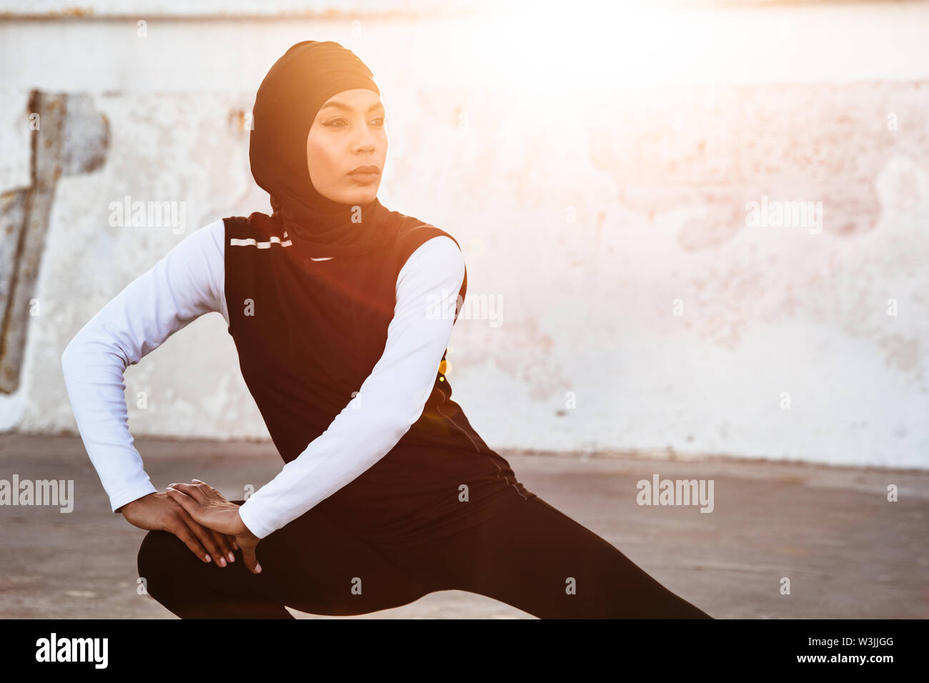 Image of a young concentrated muslim sports fitness woman dressed in ...