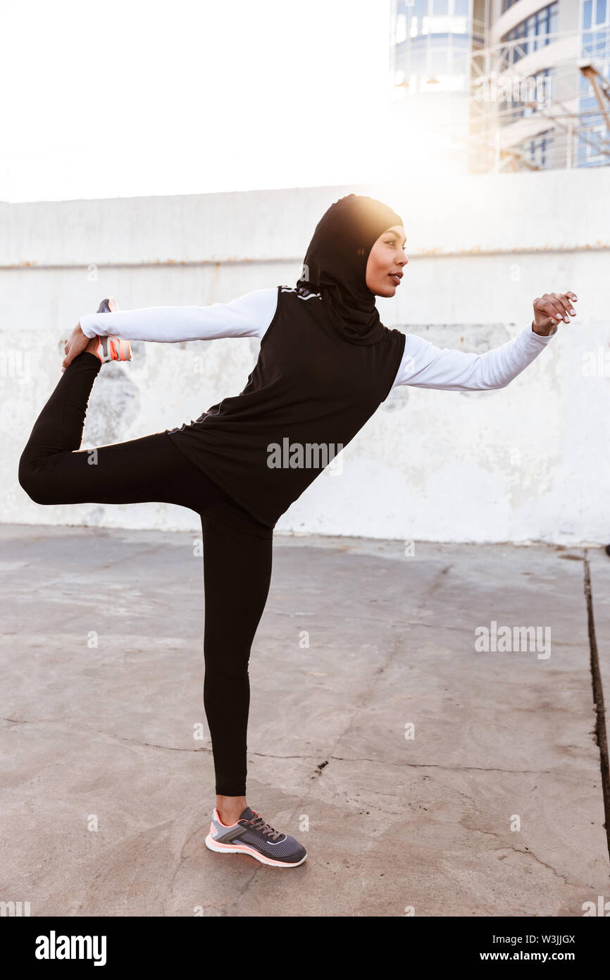 Image of a young concentrated muslim sports fitness woman dressed in ...