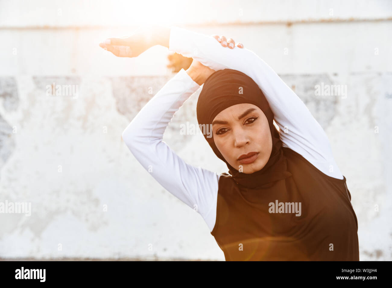 Image of a young concentrated muslim sports fitness woman dressed in ...