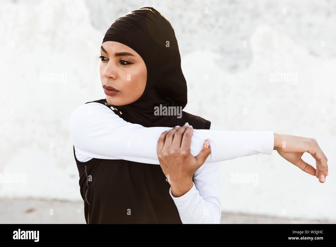 Picture of a young beautiful strong muslim sports fitness woman dressed ...