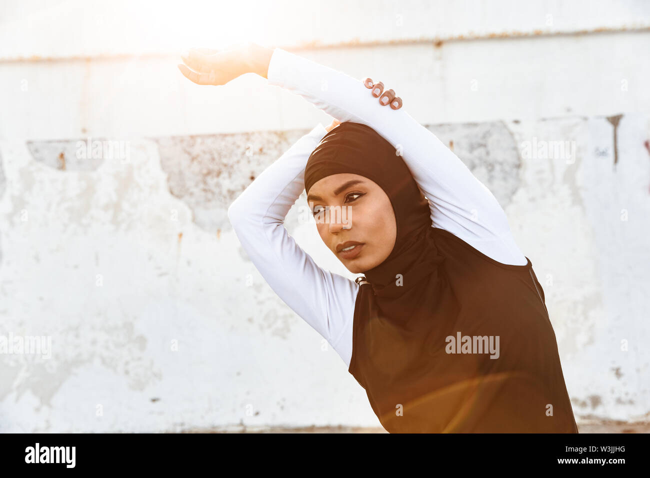 Picture of a young beautiful strong muslim sports fitness woman dressed ...