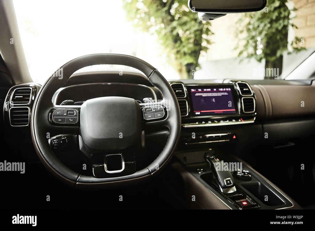 Modern luxury car Interior - steering wheel, shift lever and dashboard ...