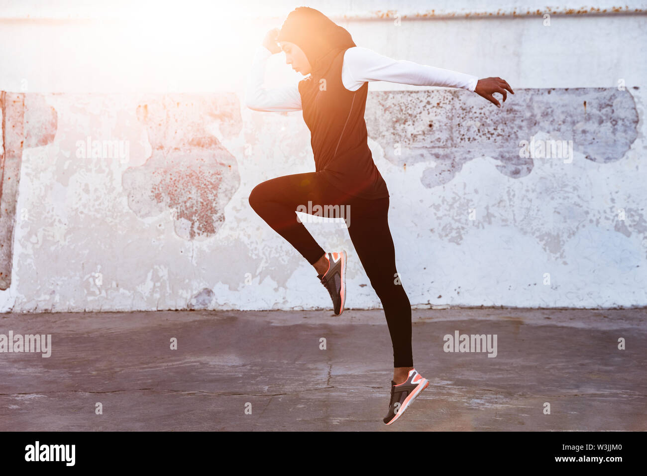 Image of a young concentrated muslim sports fitness woman dressed in ...