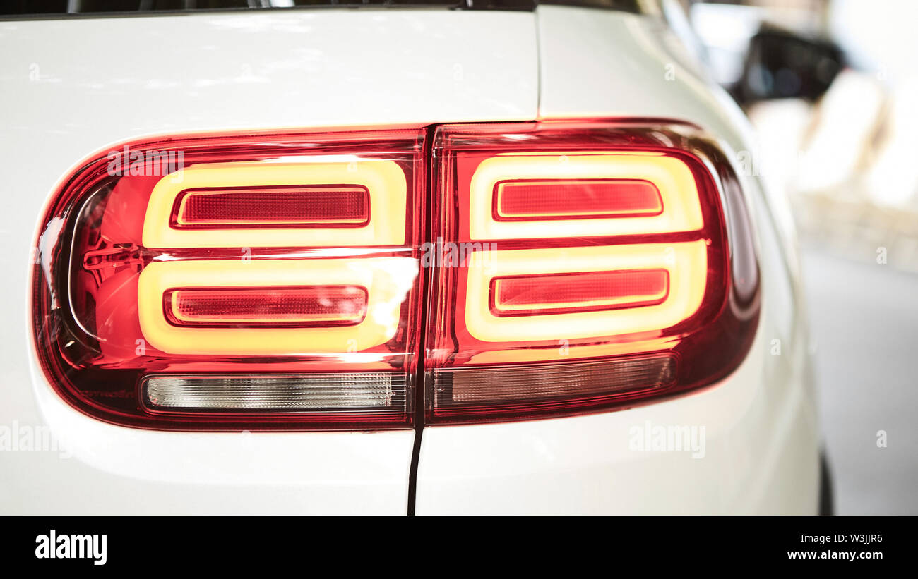 Back lights of white car. While flaming red Stock Photo - Alamy