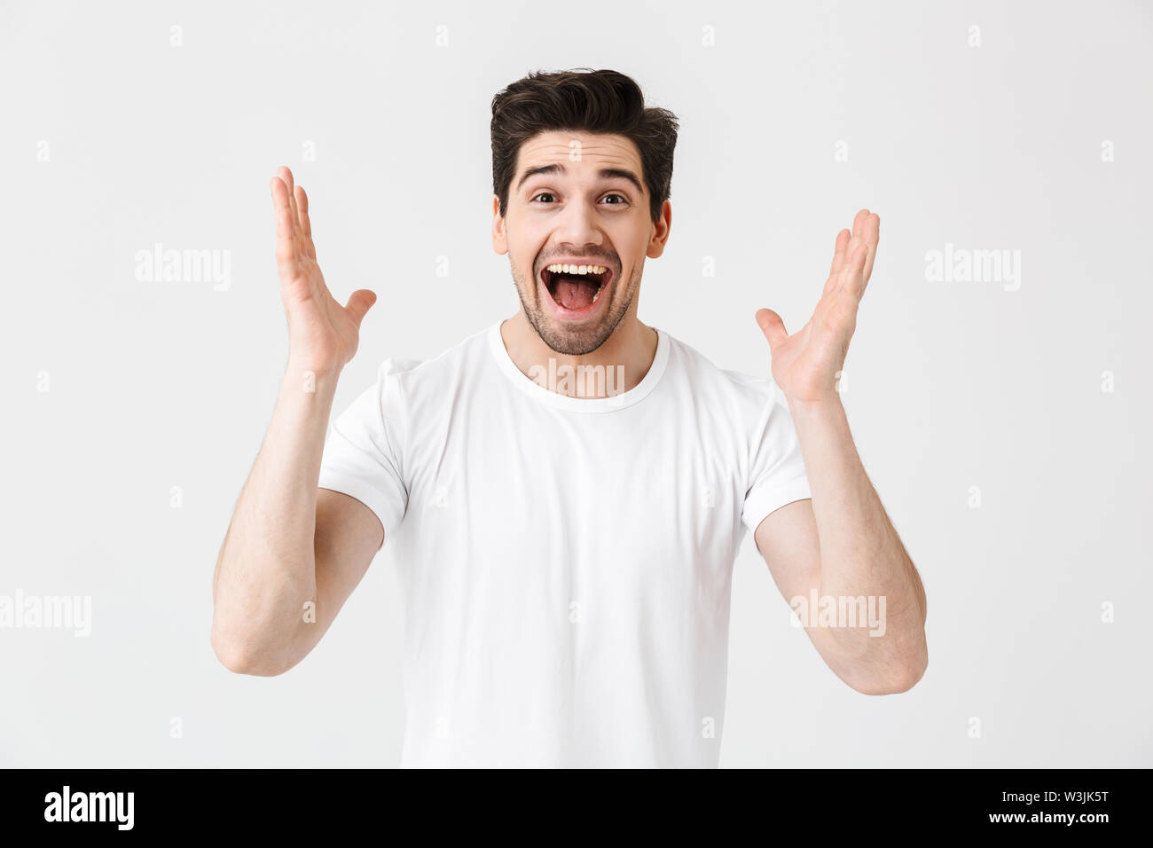 Image of a shocked surprised excited happy young man posing isolated ...