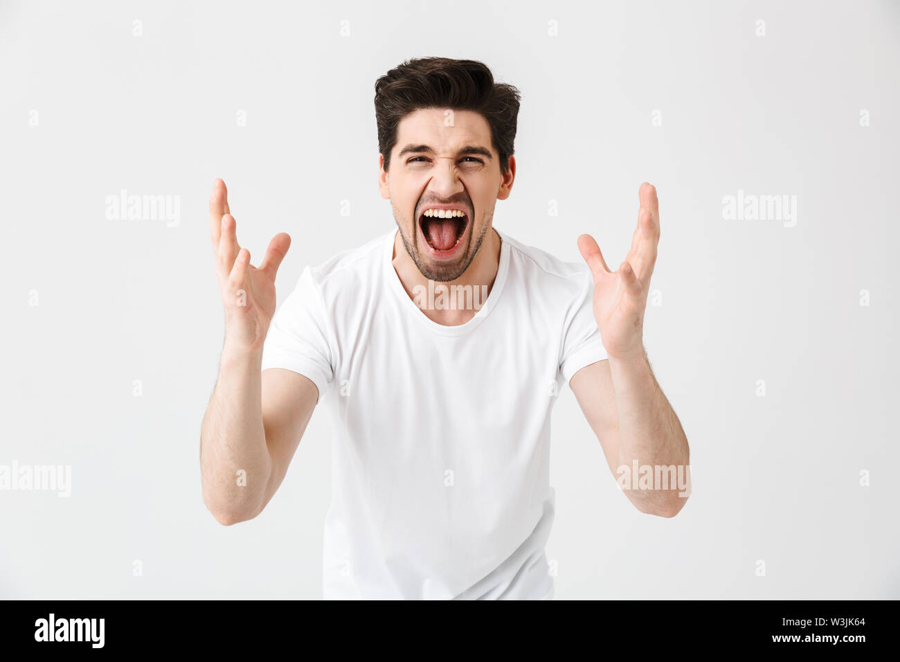 Image of a emotional screaming young man posing isolated over white ...