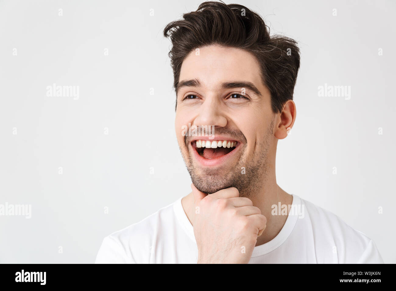 Image of a happy young excited emotional man posing isolated over white ...