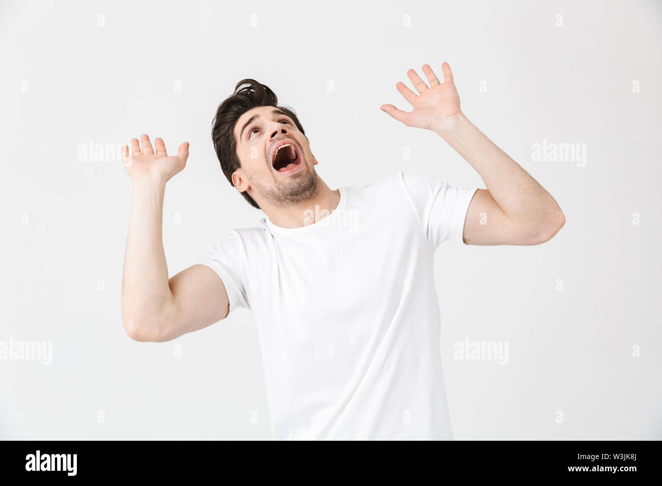 Image of screaming scared shocked young man posing isolated over white ...