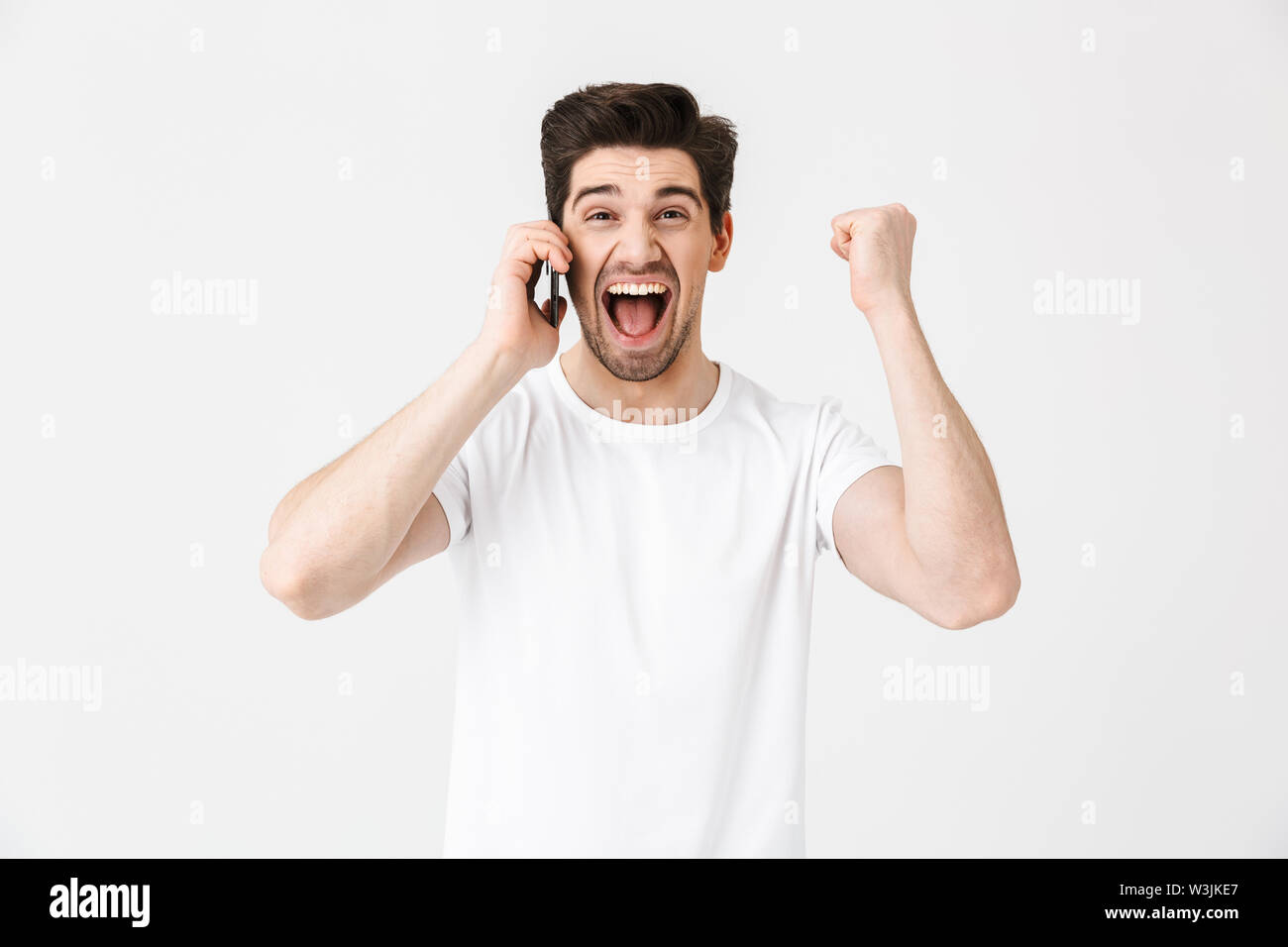 Image of happy excited shocked young man posing isolated over white ...