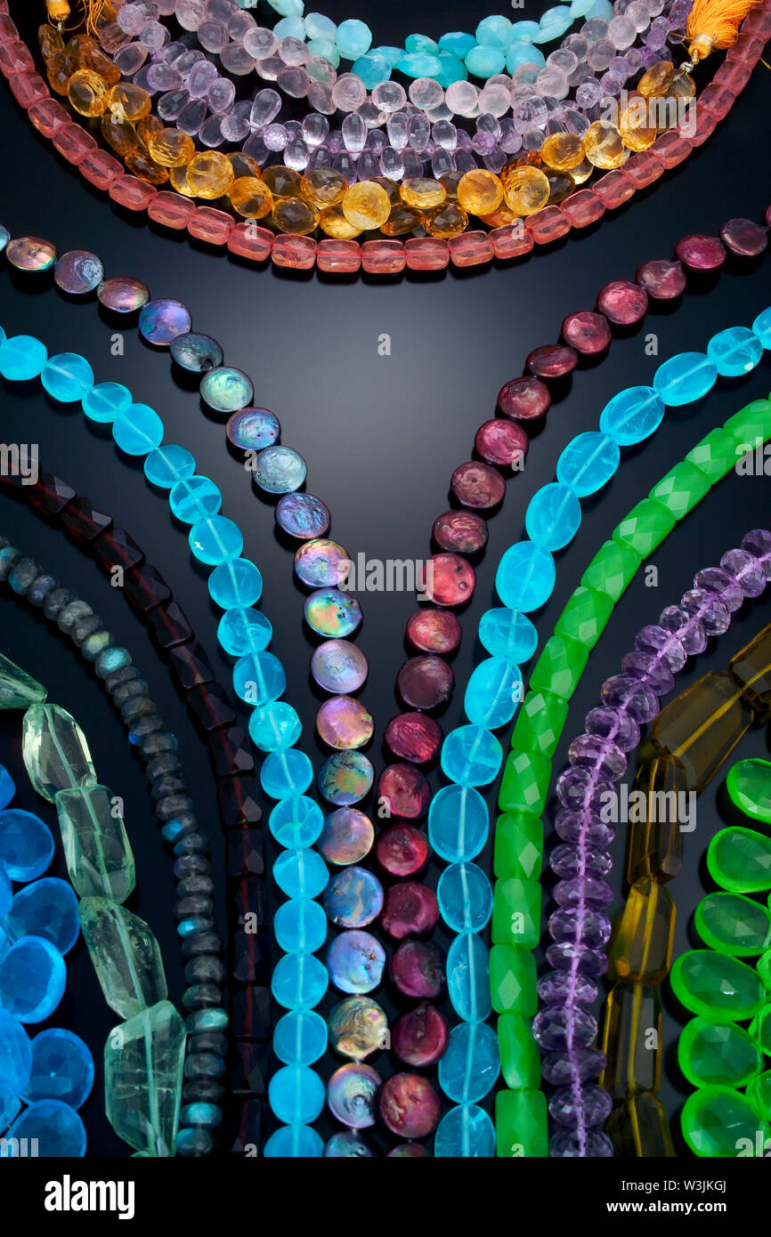 Strands of different color and materials are arranged in curves against ...