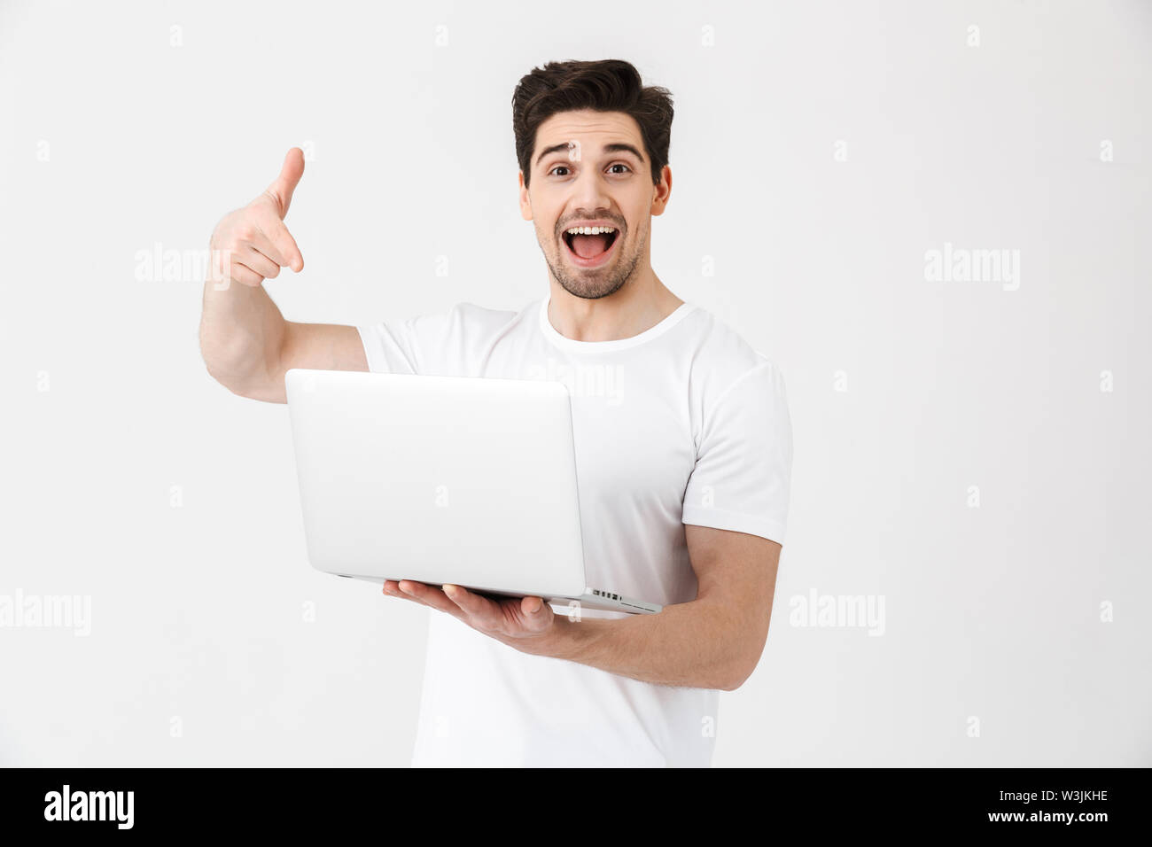 Image of happy excited young man posing isolated over white wall using ...