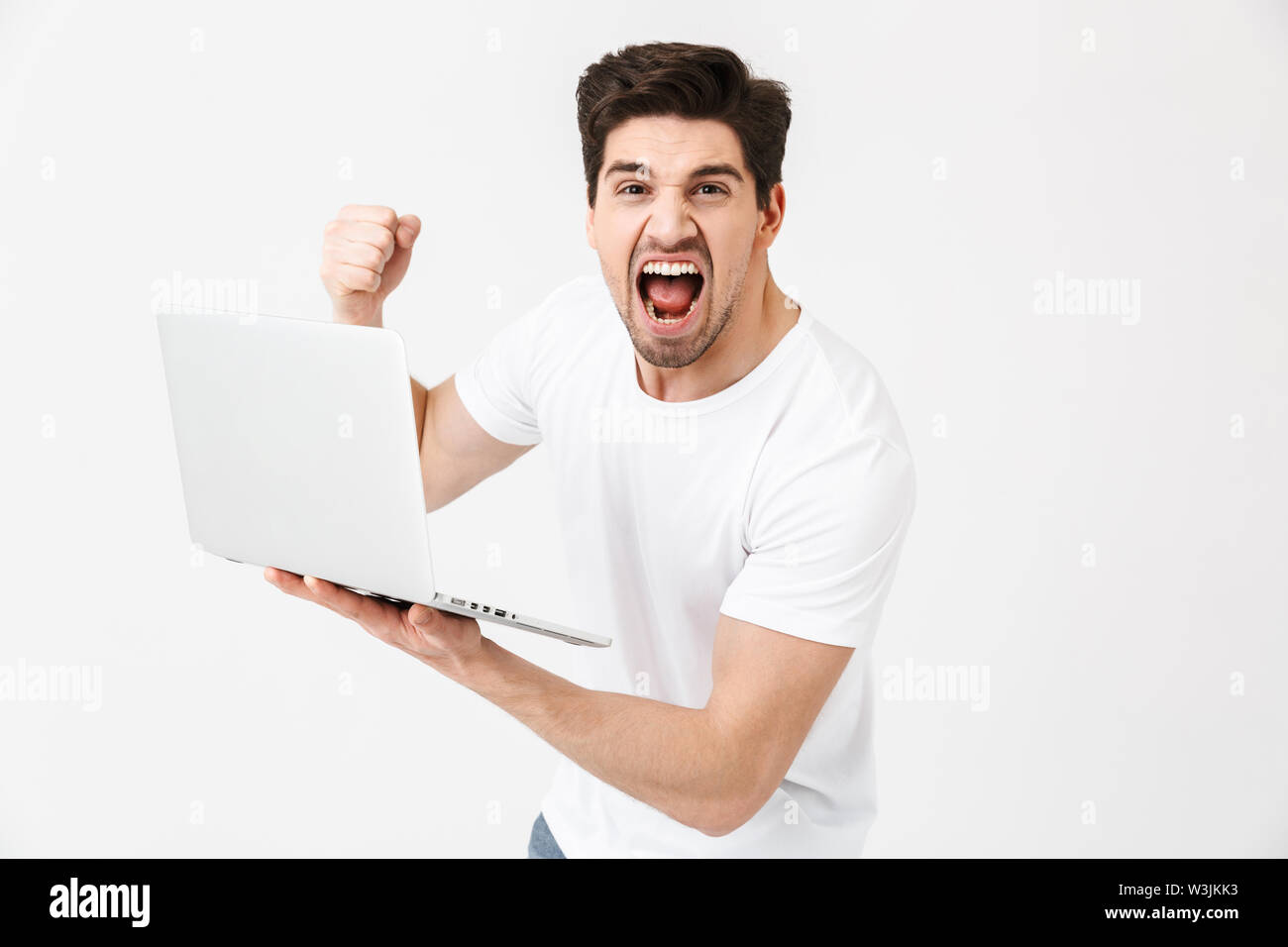 Image of shocked screaming young man posing isolated over white wall ...