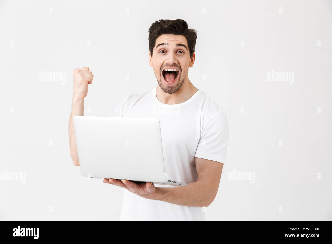 Image of happy excited young man posing isolated over white wall using ...