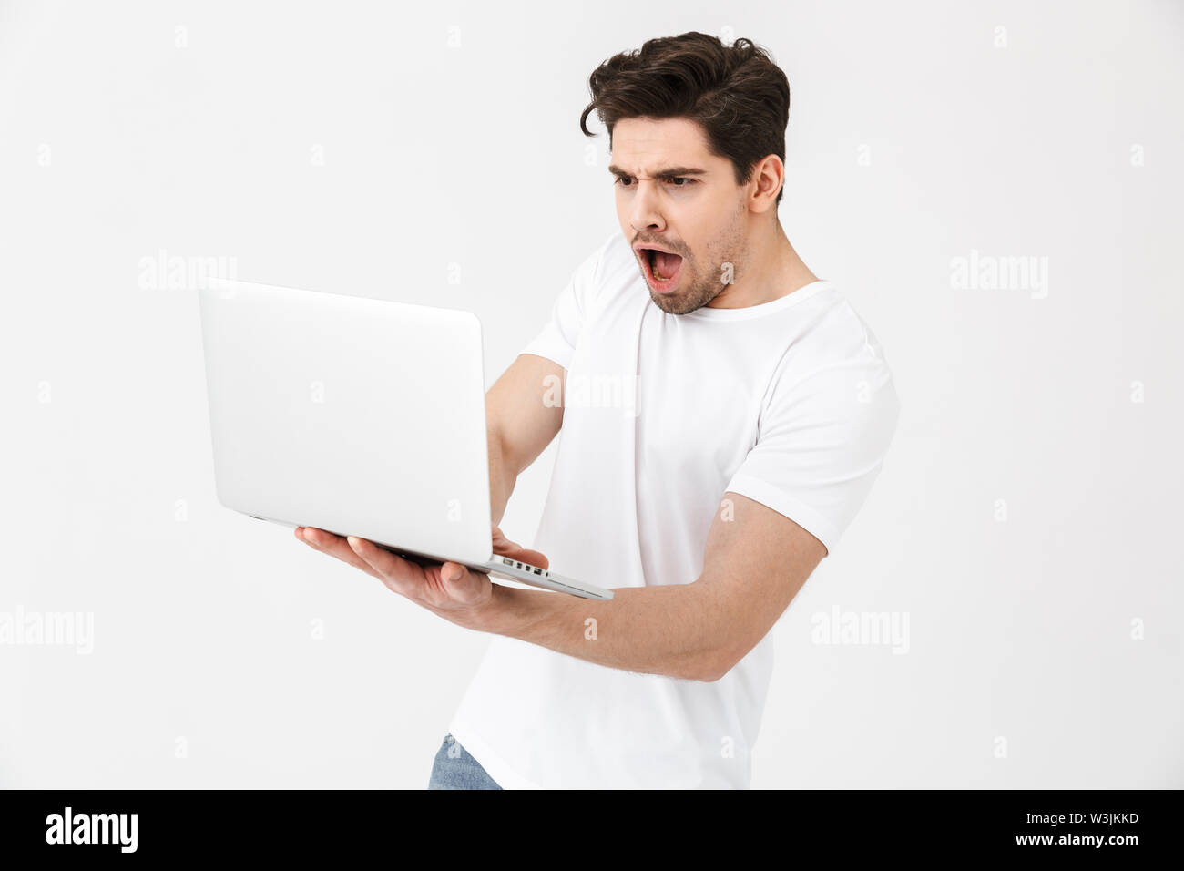 Image of shocked confused young man posing isolated over white wall ...