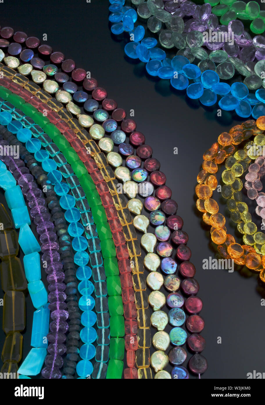 Strands of different color and materials are arranged in curves against ...