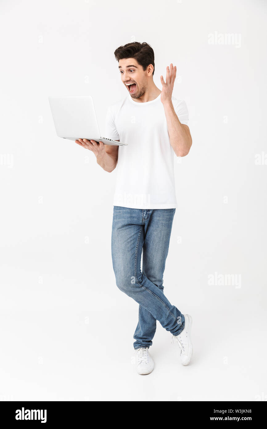 Image of shocked excited young man posing isolated over white wall ...