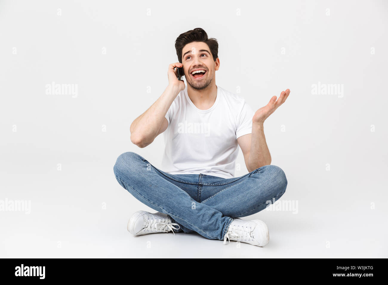 Image of a happy excited young man posing isolated over white wall ...