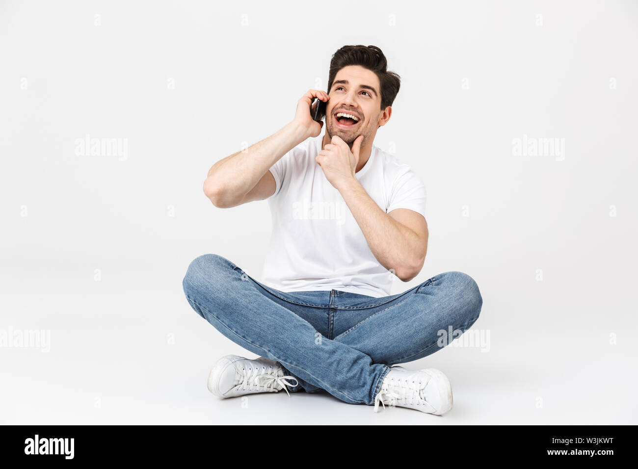 Image of a happy excited young man posing isolated over white wall ...