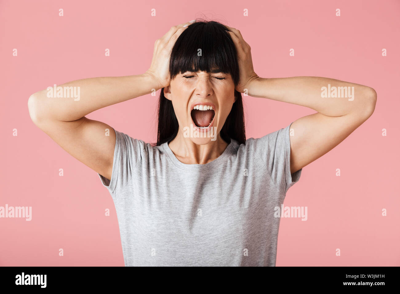 Image of a beautiful amazing shocked woman posing isolated over light ...