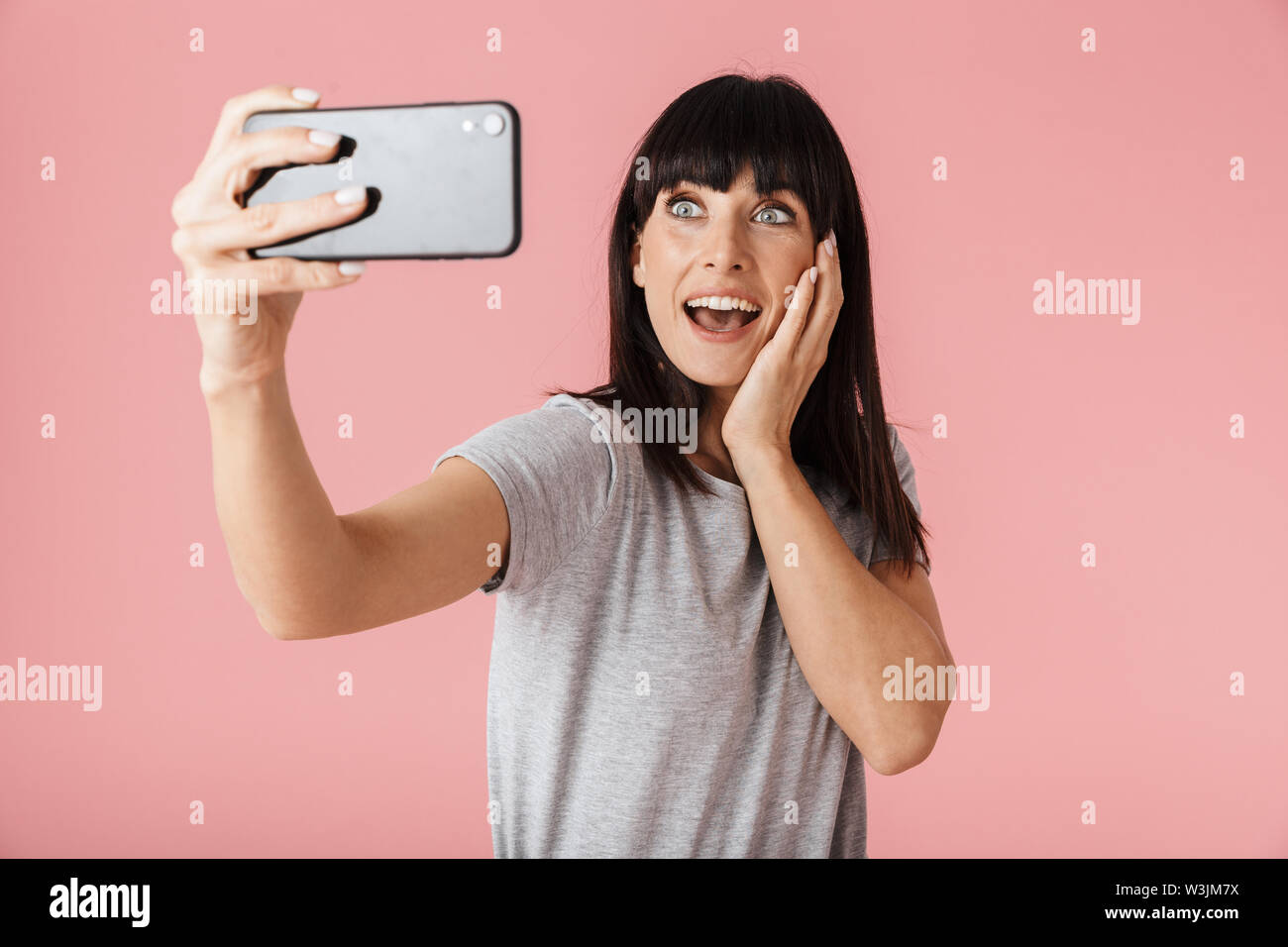 Image of a beautiful shocked amazing excited happy woman posing ...
