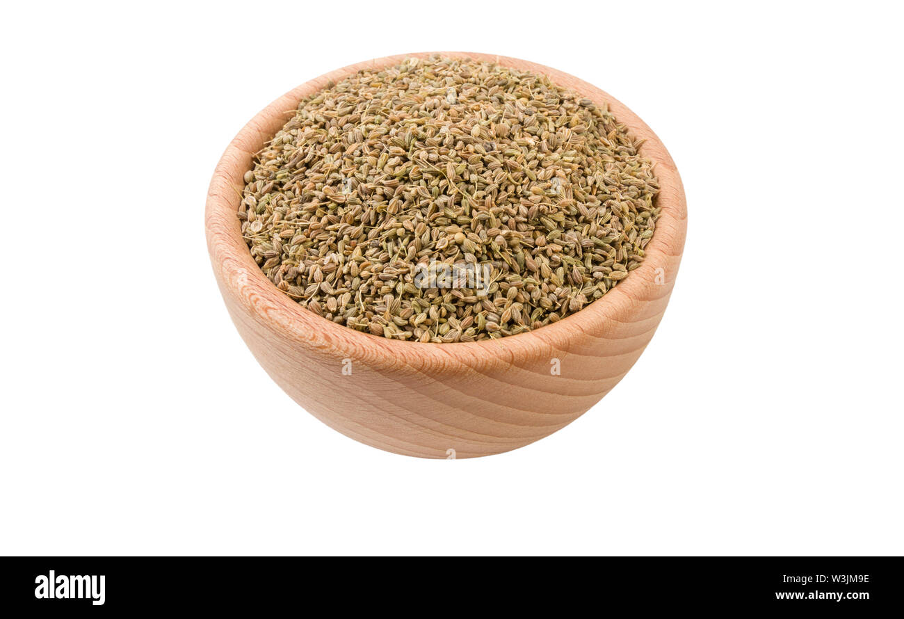 anise seeds in wooden bowl isolated on white background. 45 degree view ...