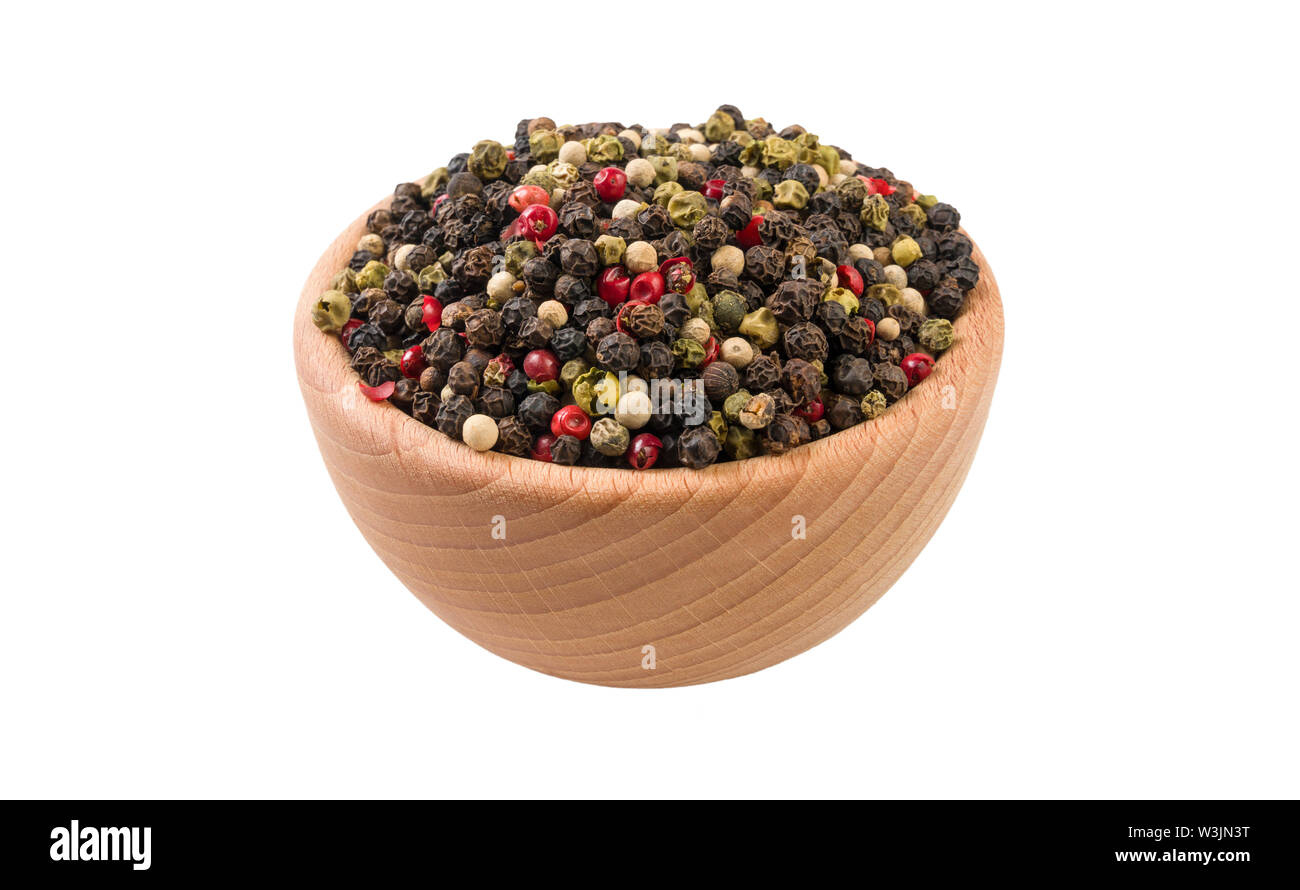 colored pepper peppercorns in wooden bowl isolated on white background ...